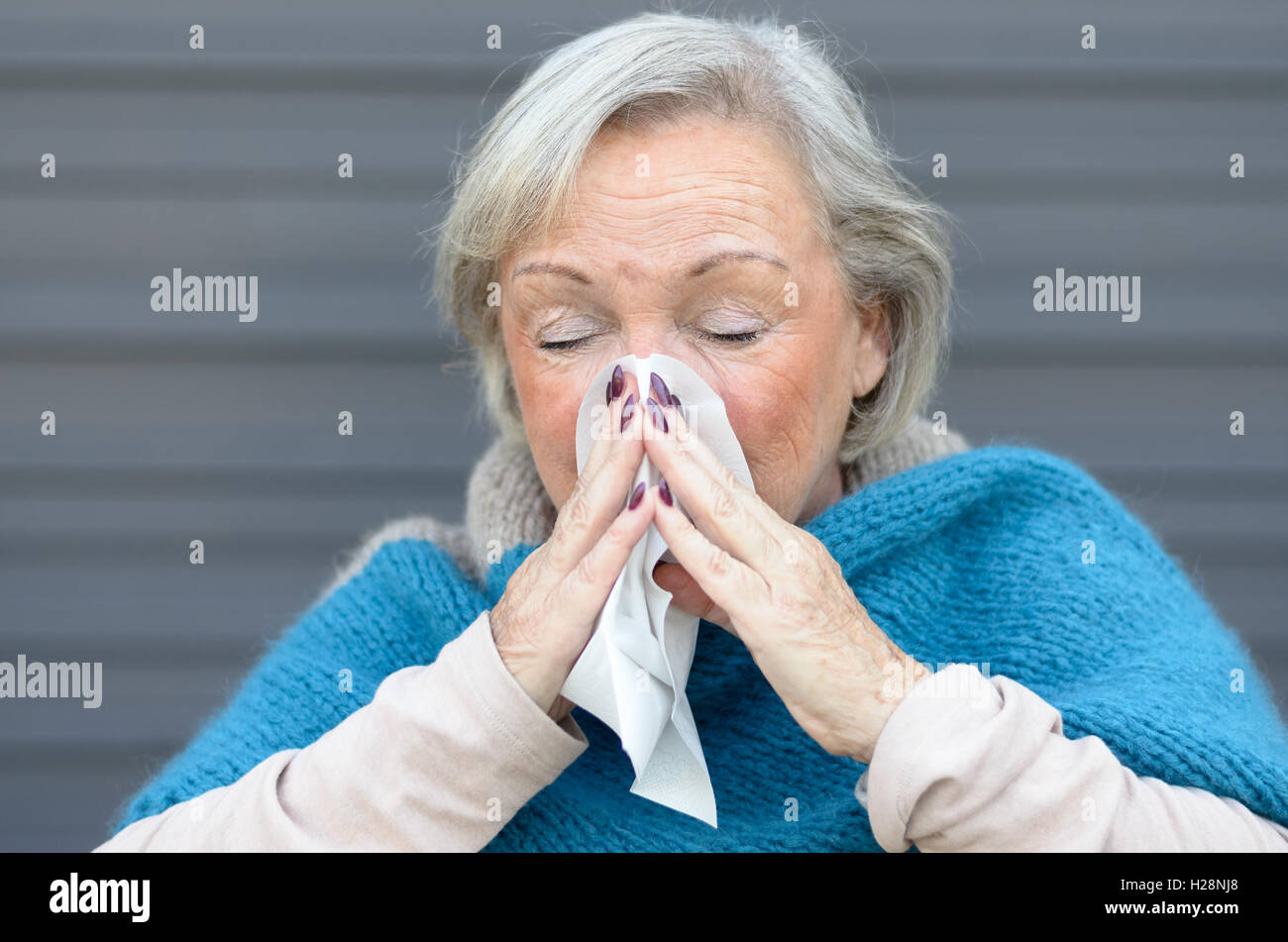 Elderly woman with seasonal influenza, a cold, rhinitis or allergic ...