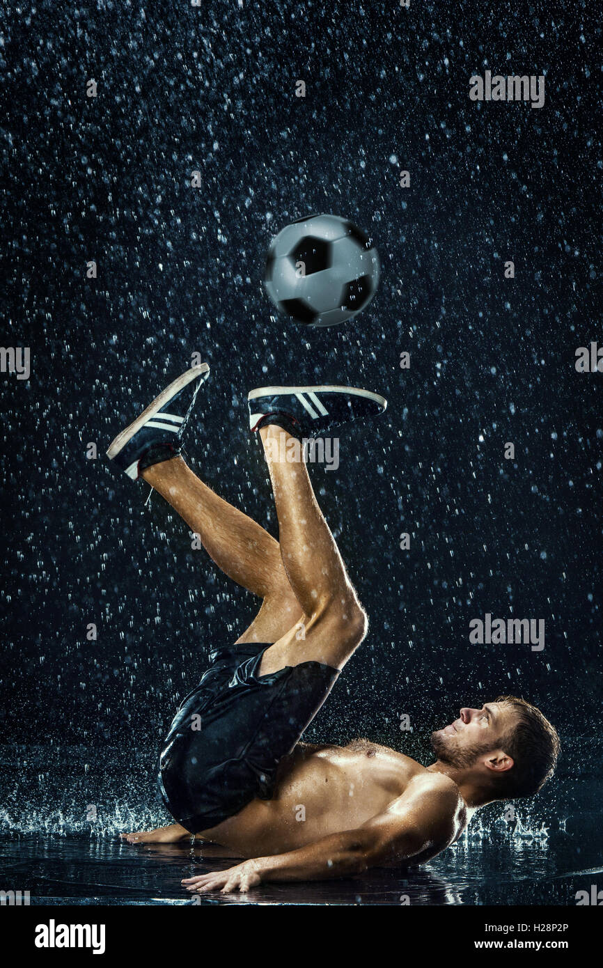 Water drops around football player under water Stock Photo - Alamy
