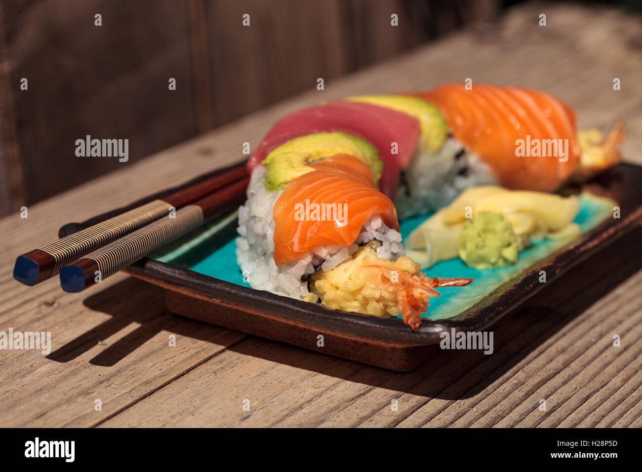 Dragon roll sushi with salmon, tuna, avocado, shrimp tempura and rice ...