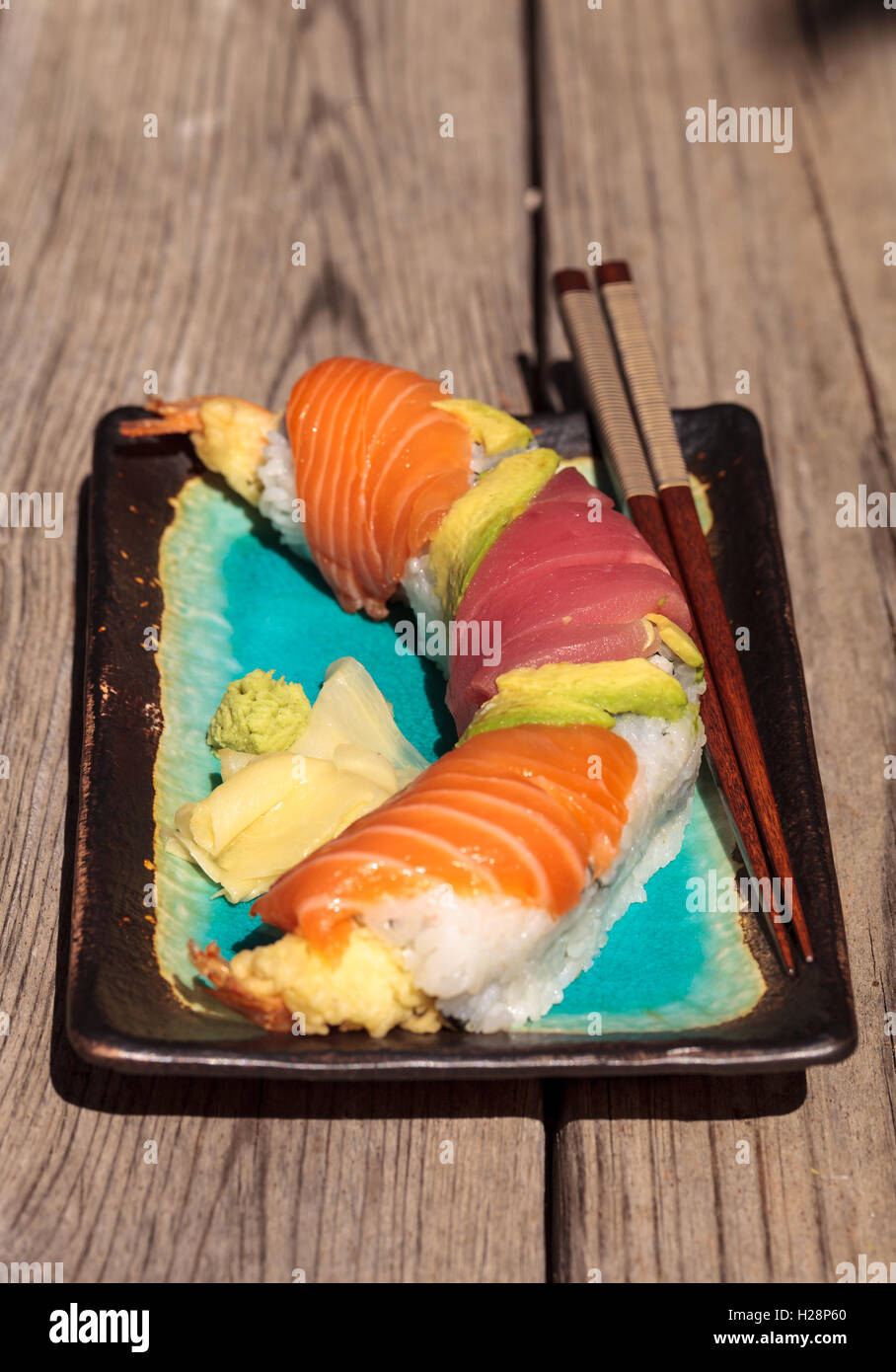 Dragon roll sushi with salmon, tuna, avocado, shrimp tempura and rice ...