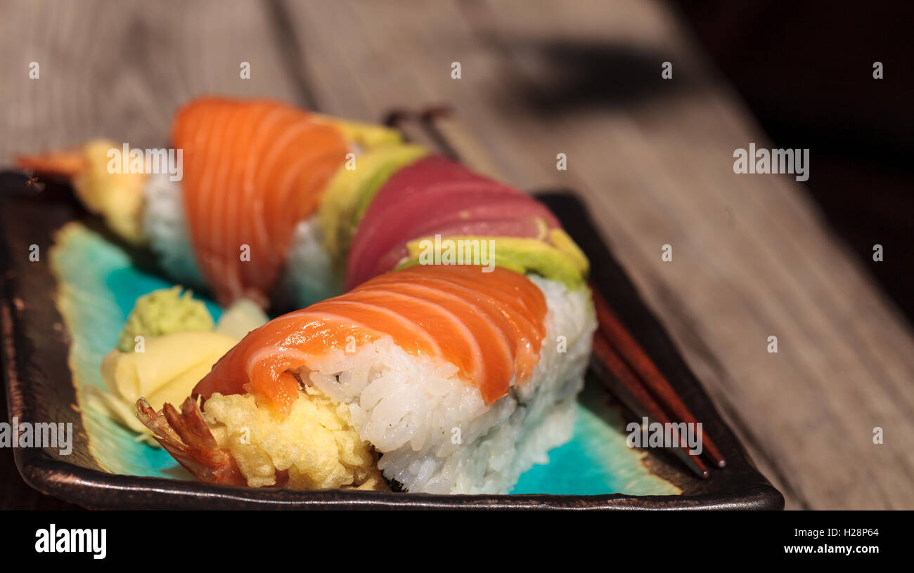 Dragon roll sushi with salmon, tuna, avocado, shrimp tempura and rice ...
