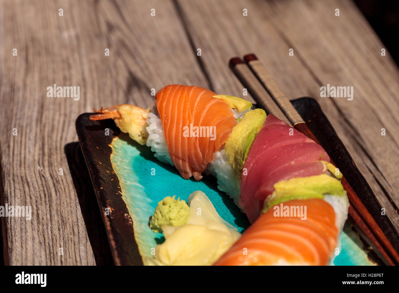 Dragon roll sushi with salmon, tuna, avocado, shrimp tempura and rice ...