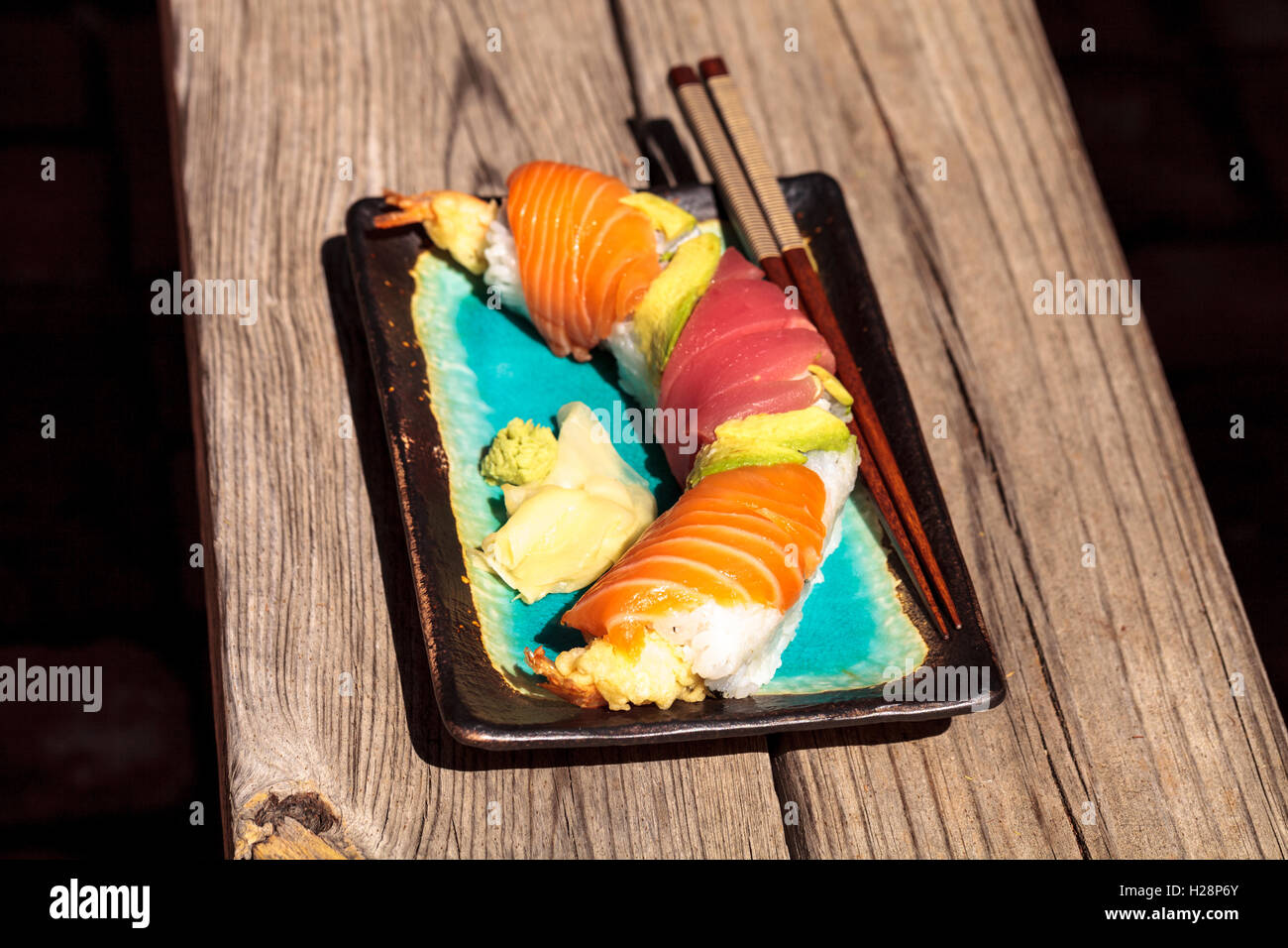 Dragon roll sushi with salmon, tuna, avocado, shrimp tempura and rice ...