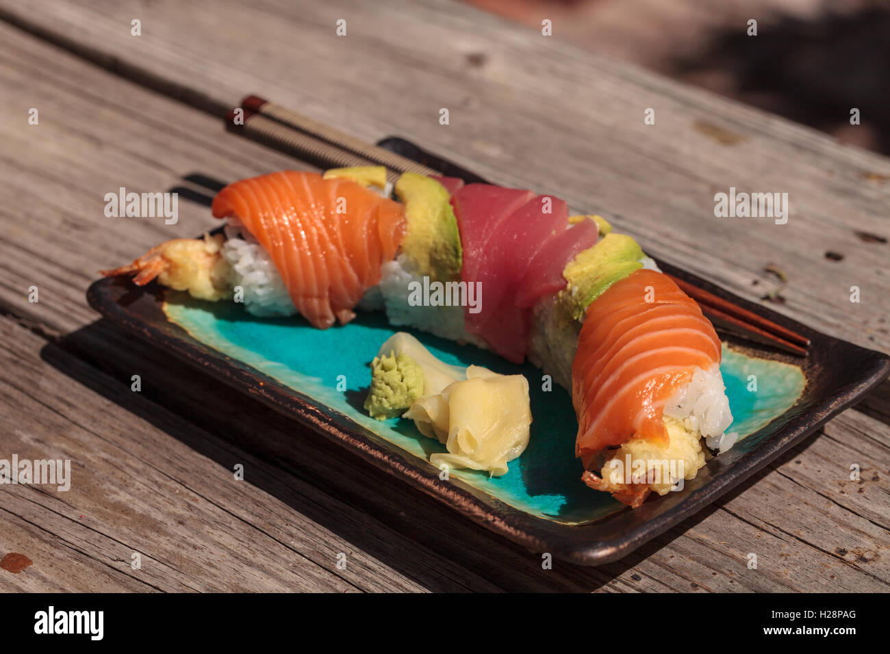 Dragon roll sushi with salmon, tuna, avocado, shrimp tempura and rice ...