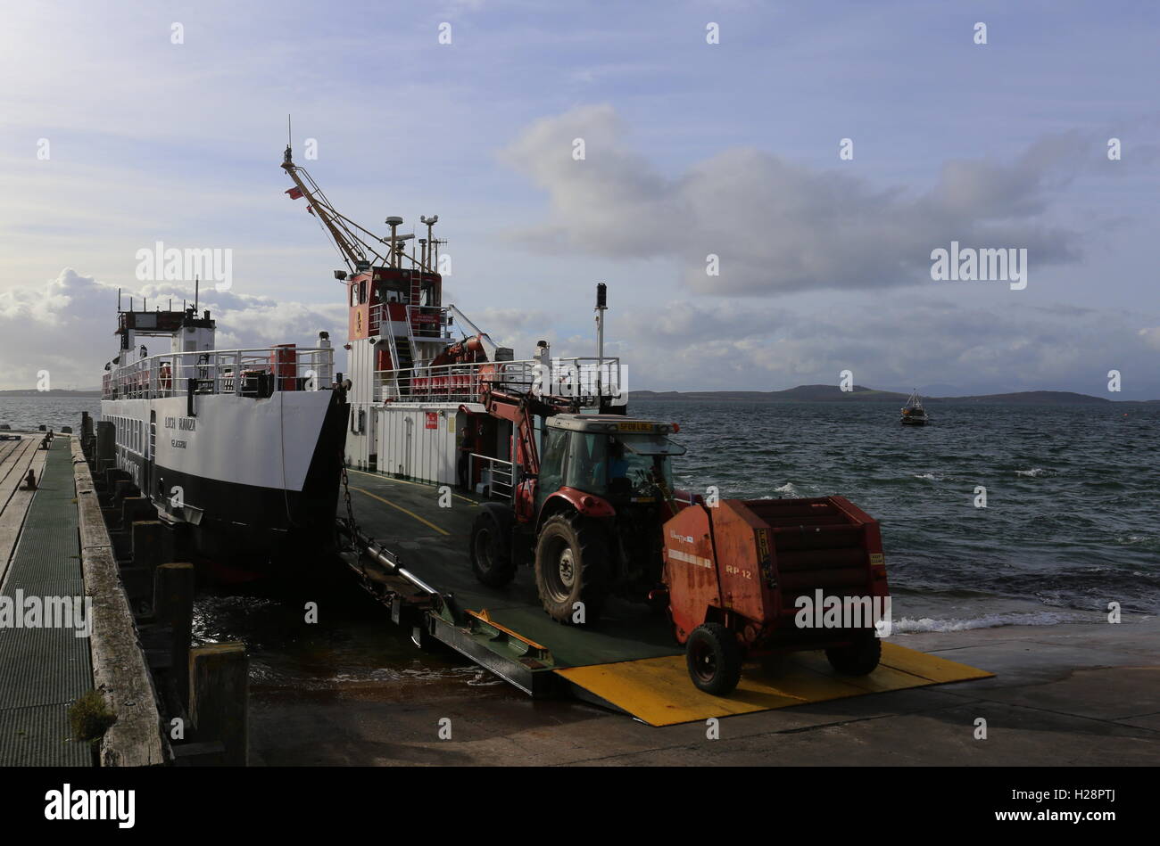 Tractor driving onto Calmac ferry MV Loch Ranza Tayinloan Kintyre ...
