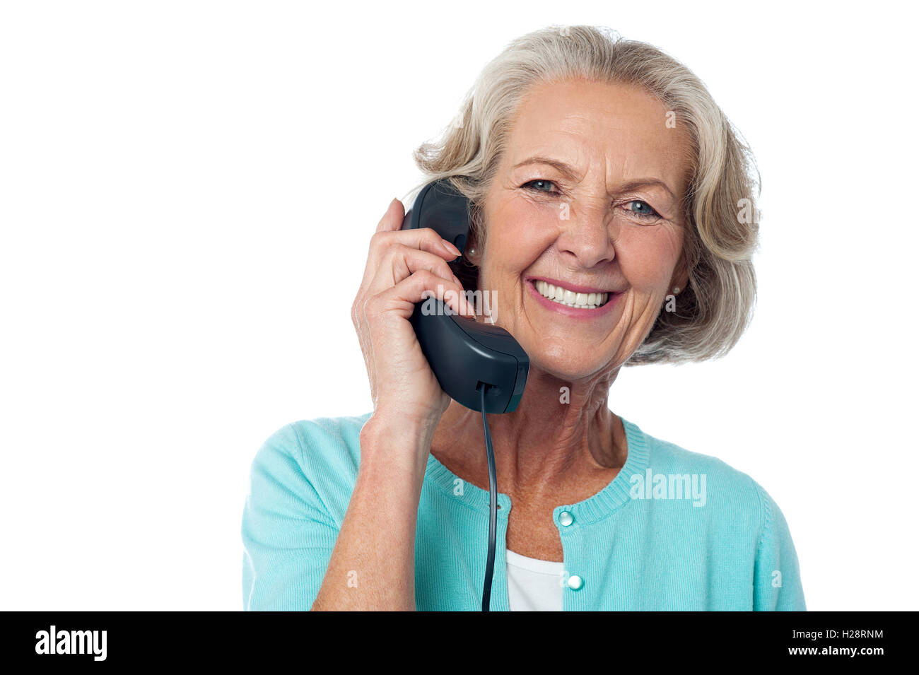 Senior lady holding phone receiver Stock Photo - Alamy