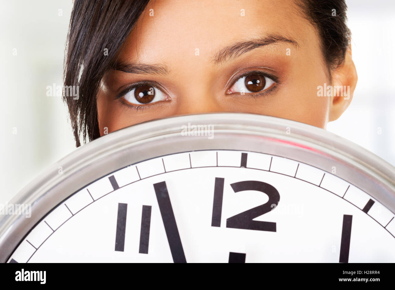 Portrait of shocked woman with clock Stock Photo - Alamy