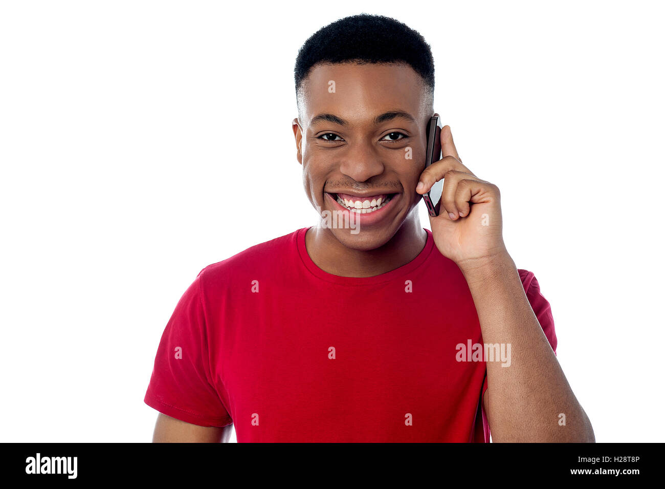 Smiling guy attending a phone call Stock Photo - Alamy
