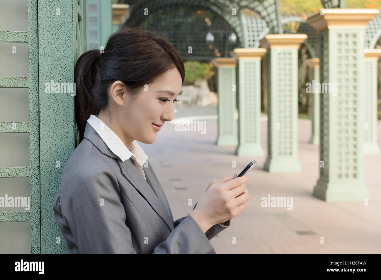 Attractive business woman use smart phone Stock Photo - Alamy