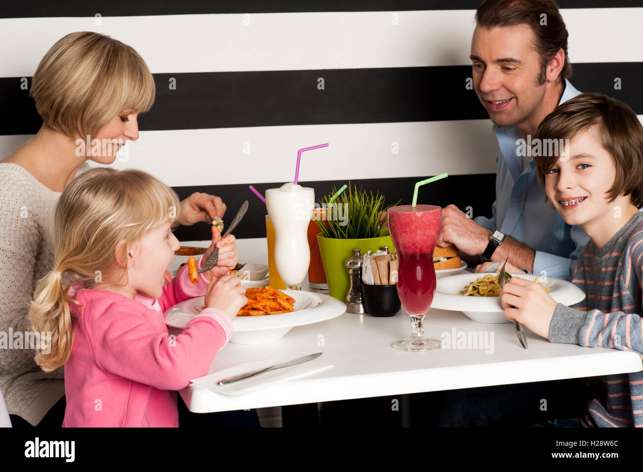 Family toasting smoothies in restaurant Stock Photo - Alamy