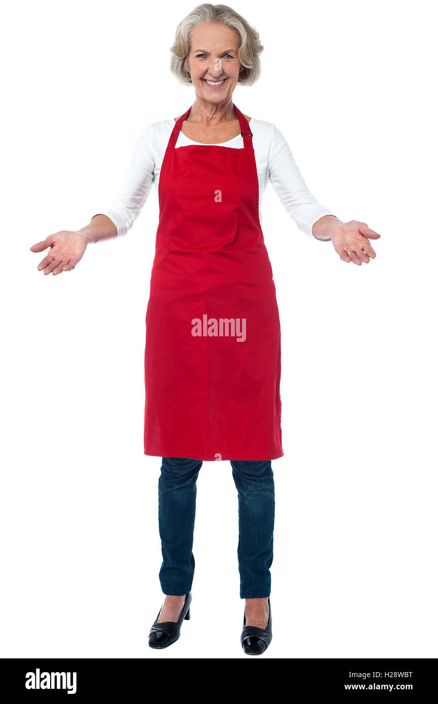 Happy aged chef gesturing welcome Stock Photo - Alamy