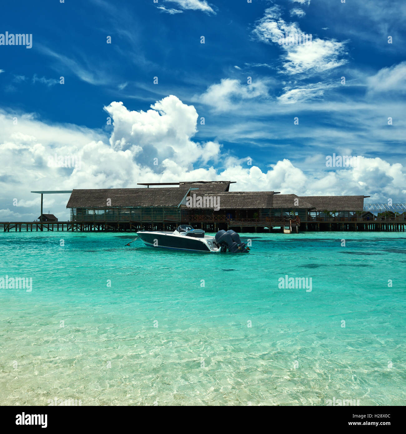 Beautiful island beach with motor boat Stock Photo - Alamy