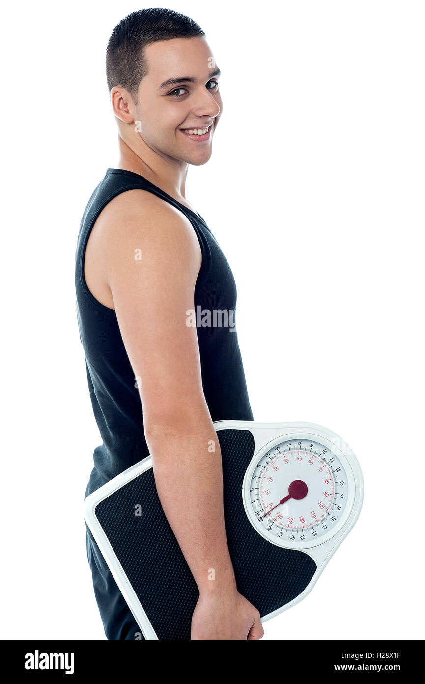 Fitness man with weighing scale Stock Photo - Alamy
