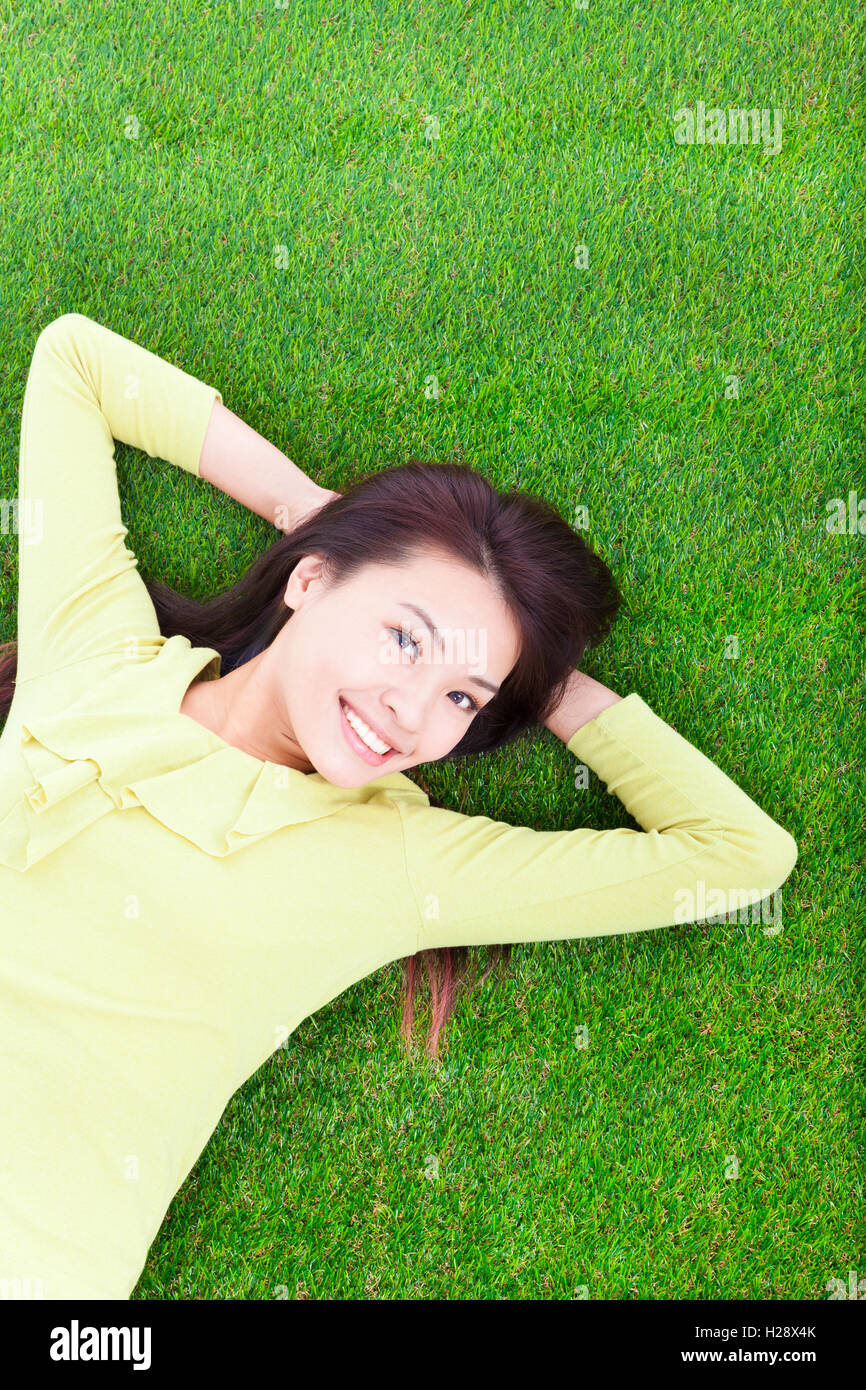 beautiful young woman laying down in park Stock Photo - Alamy