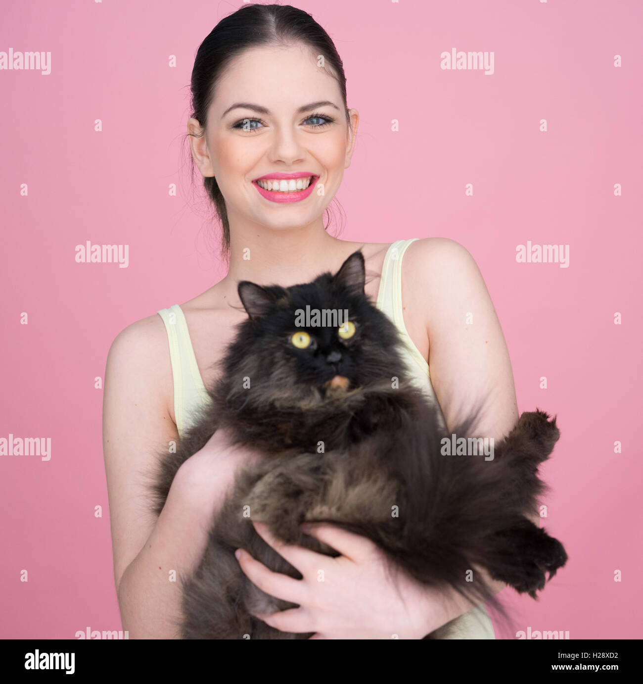 Young woman holding a black cat hi-res stock photography and images - Alamy