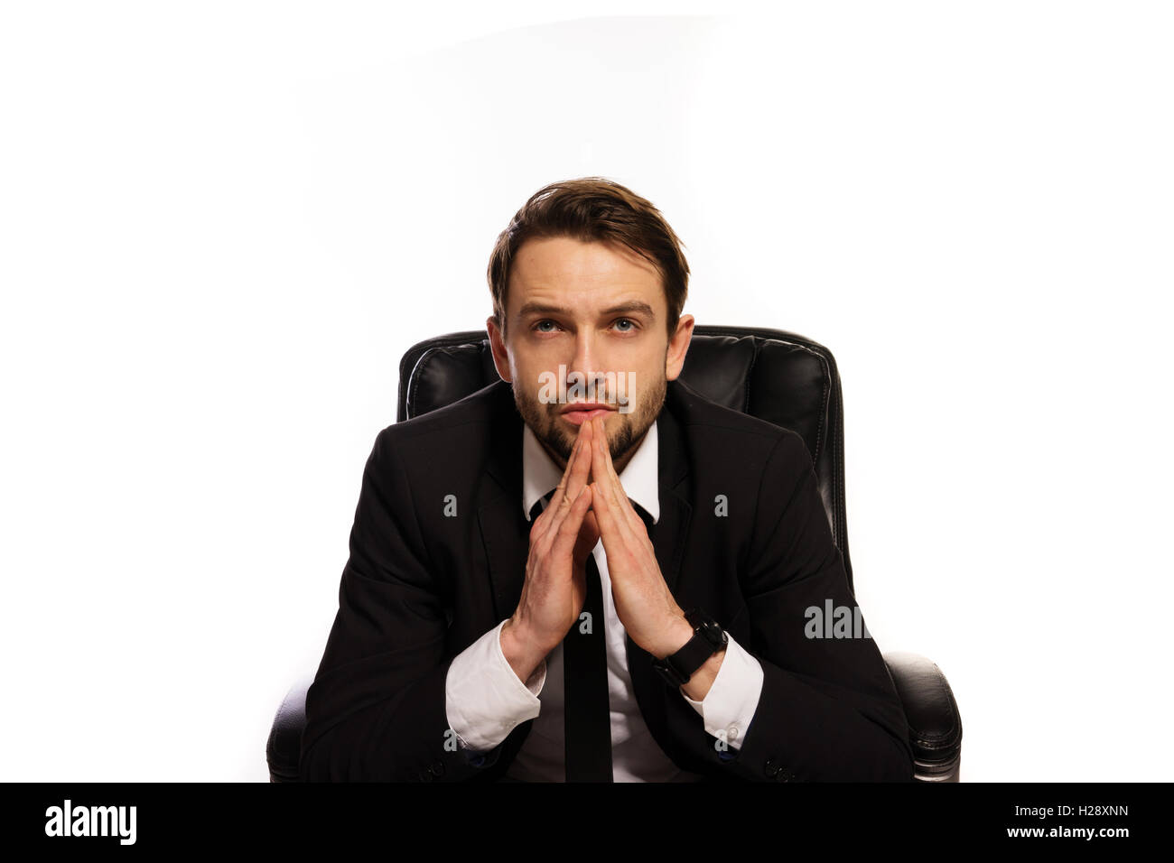 Thoughtful boss sitting at his desk Stock Photo - Alamy