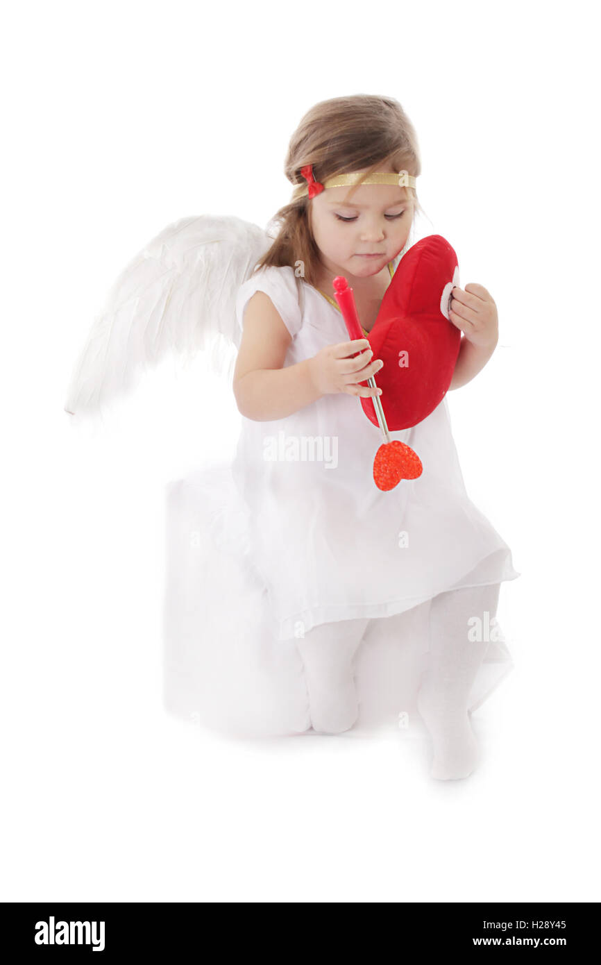Sad cupid girl sitting with heart Stock Photo - Alamy