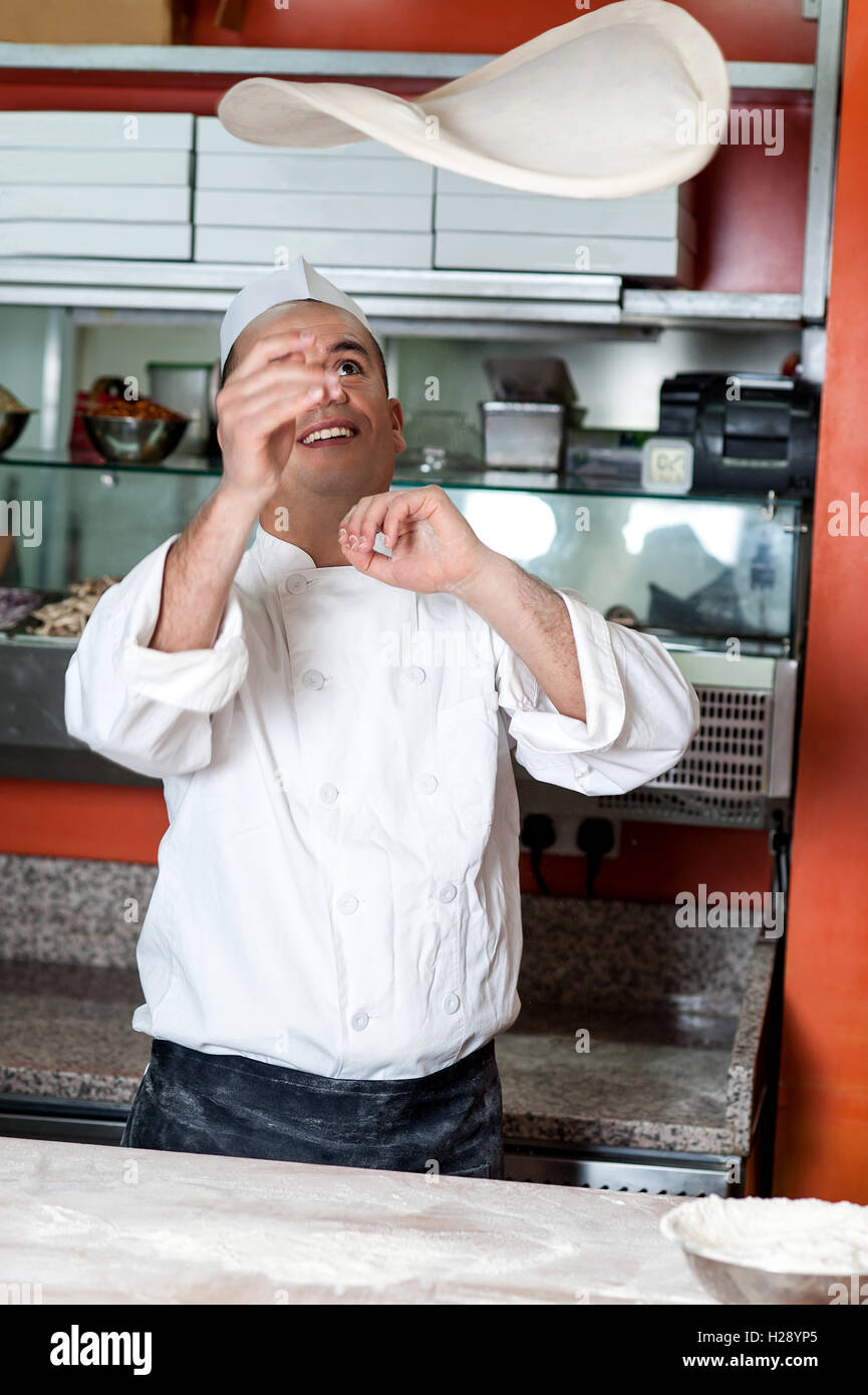 Chef throwing the pizza base dough Stock Photo - Alamy