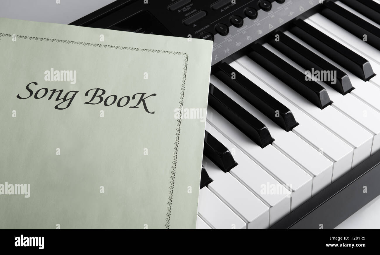 Piano keys and song book Stock Photo - Alamy