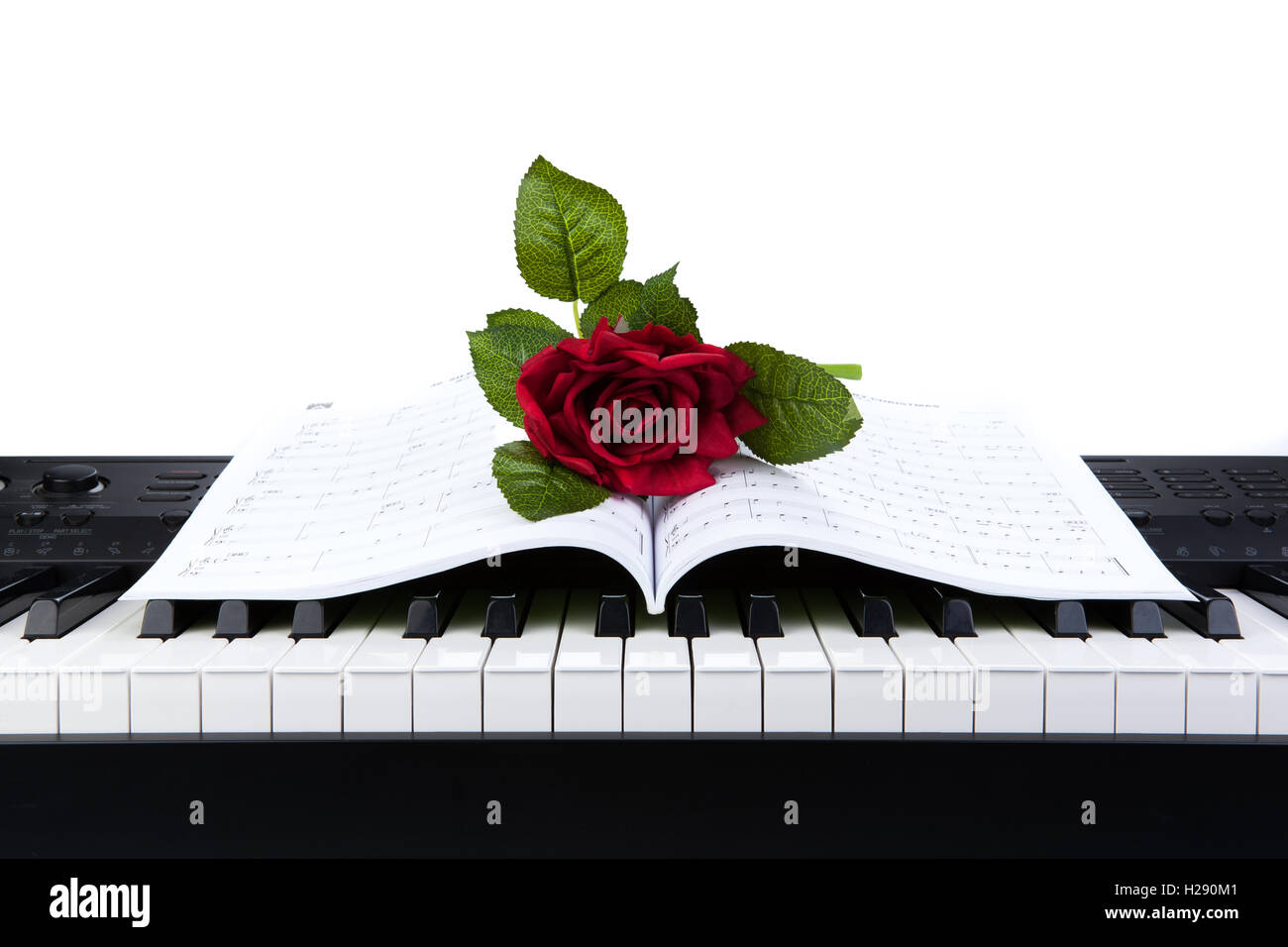 Piano keys and rose flower on note book Stock Photo - Alamy