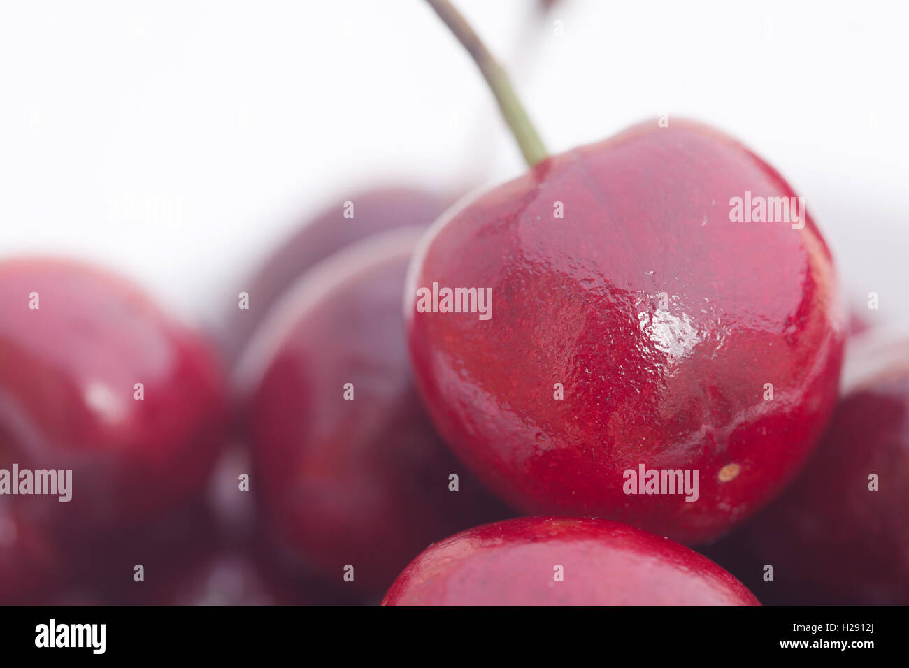 big cherries isolated on white Stock Photo - Alamy