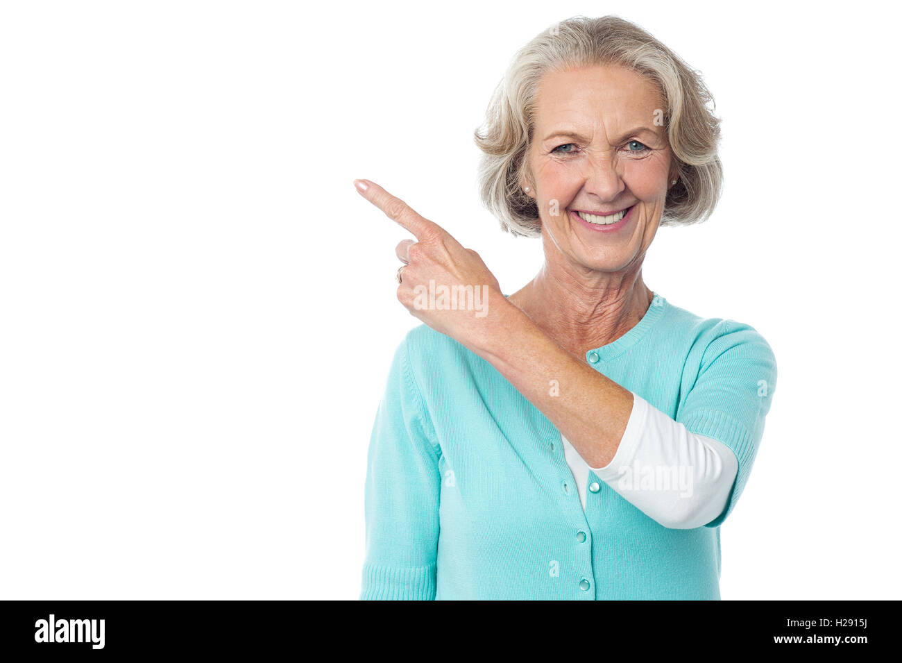 Pretty aged woman pointing at something Stock Photo - Alamy