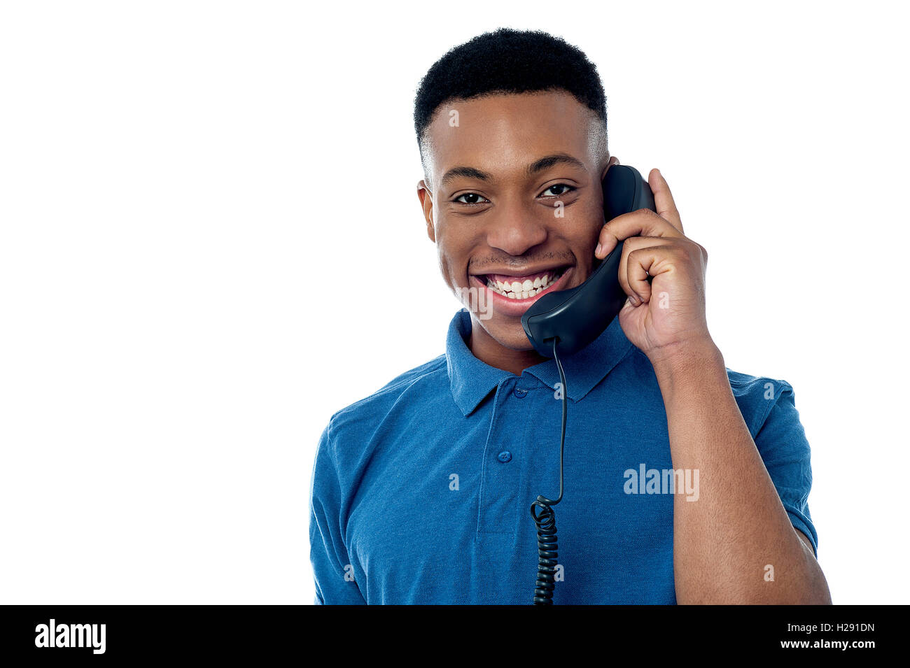 Young man attending phone call Stock Photo - Alamy