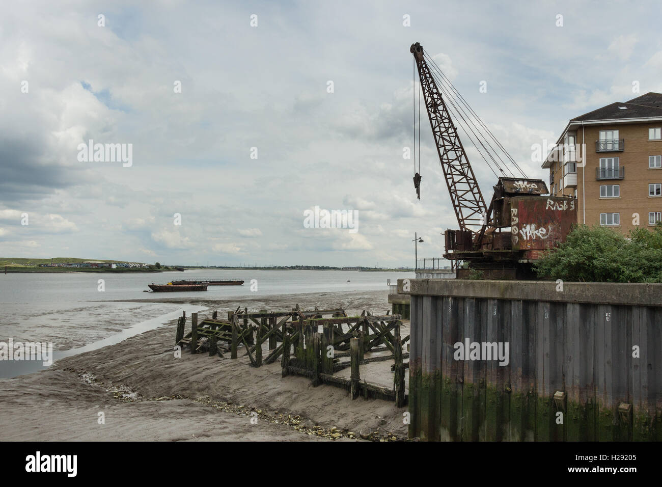 Old derelict industrial crane at Erith Quay side contrasts with ...