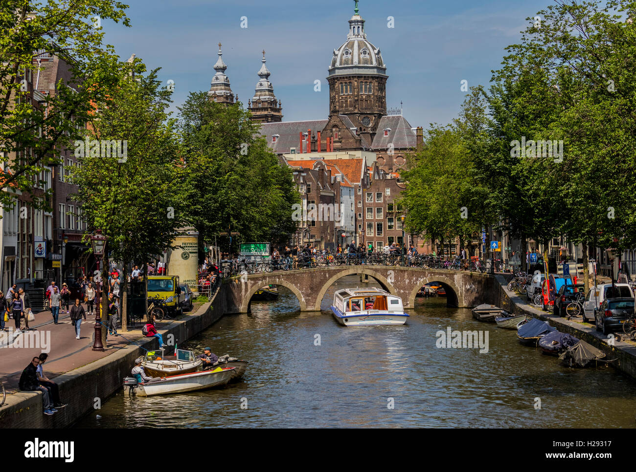 Locals and tourist walking along one of Hollands beautiful canals in ...