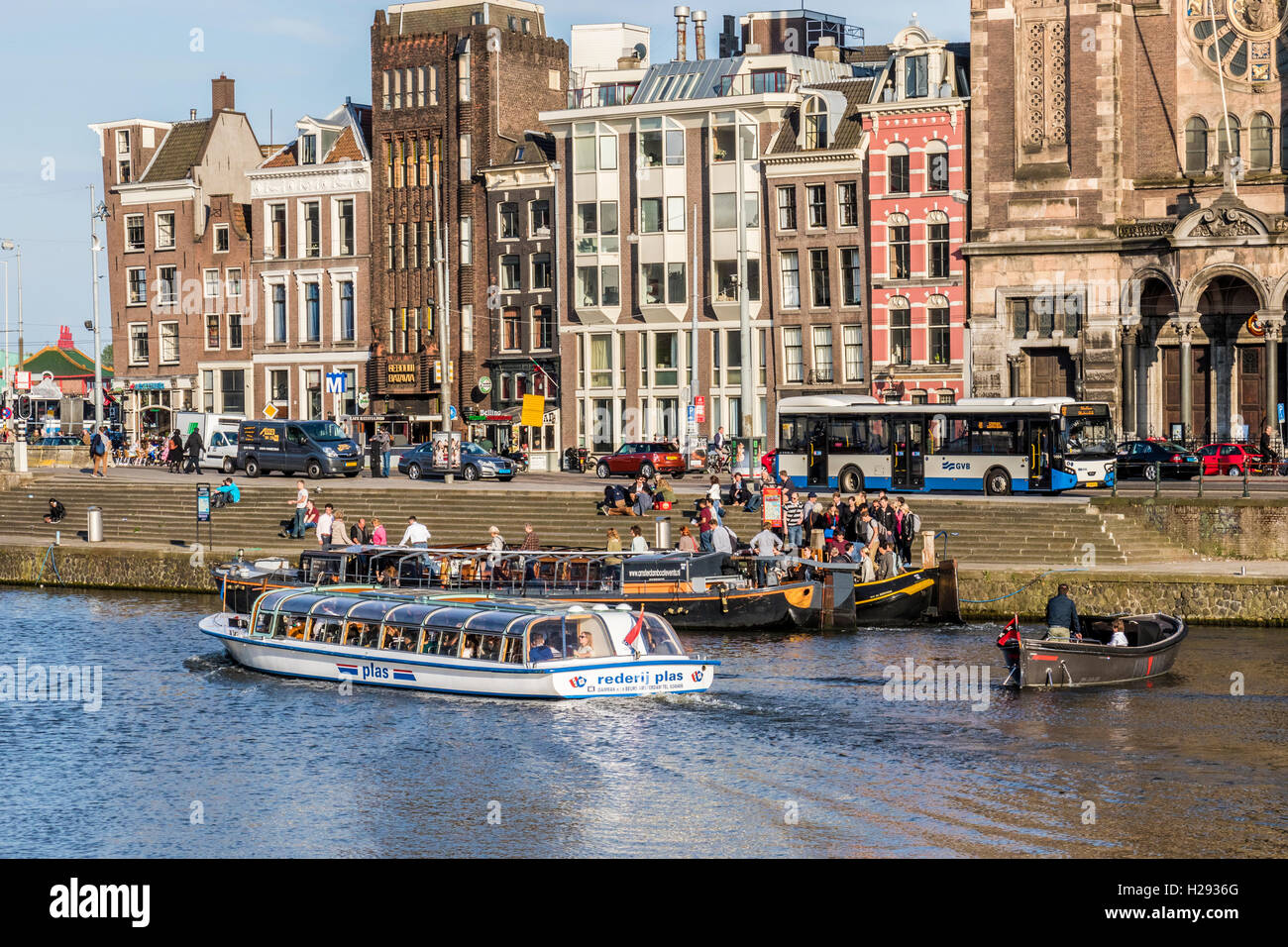 Locals and tourist taking a trip in a tourist boat along one of ...