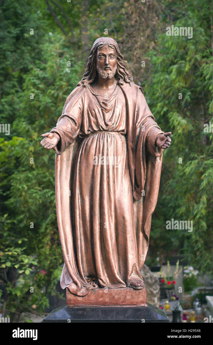 Statue of Jesus standing on a pedestal in a cemetery Stock Photo - Alamy