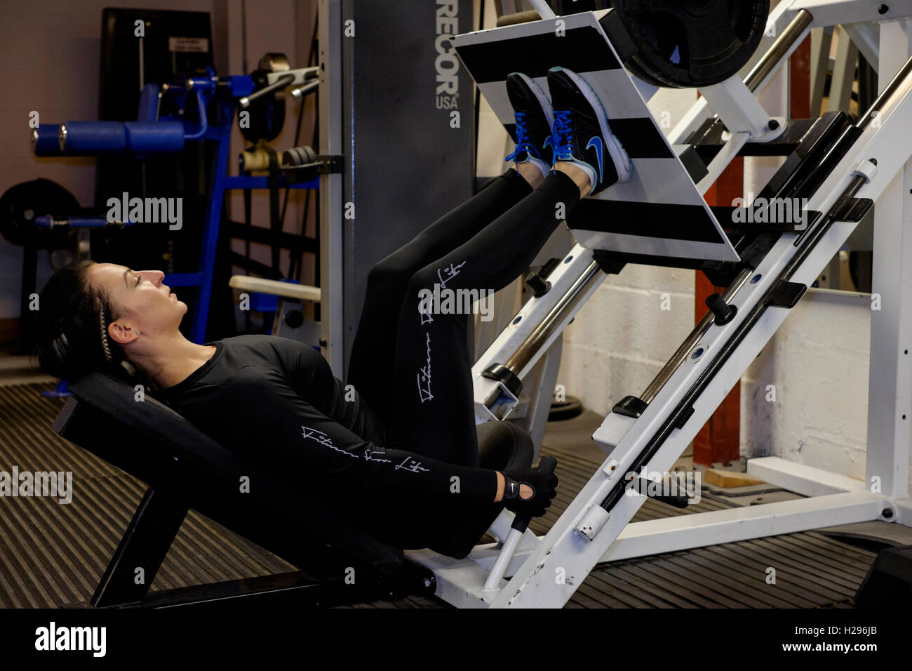 young female strengthening legs working out in a gym england uk Stock ...