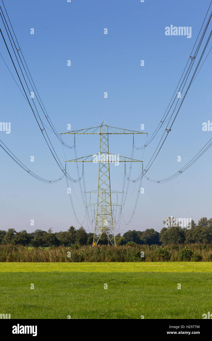 Electric powerlines across a beautiful field Stock Photo - Alamy
