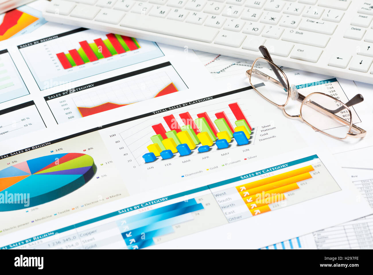 glasses, business papers with charts Stock Photo - Alamy