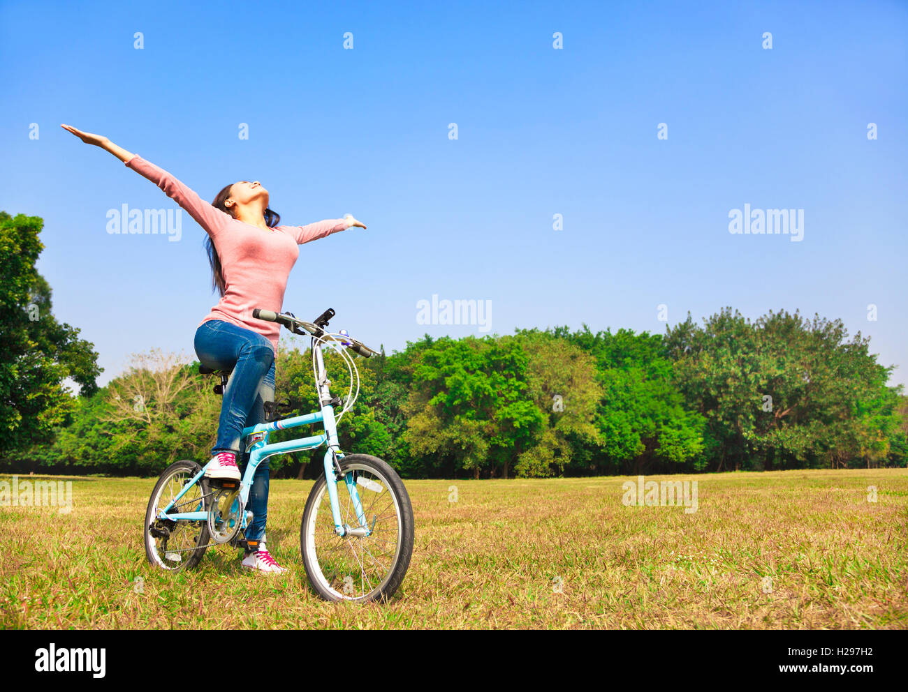 young woman relaxing pose and sitting on bike Stock Photo - Alamy