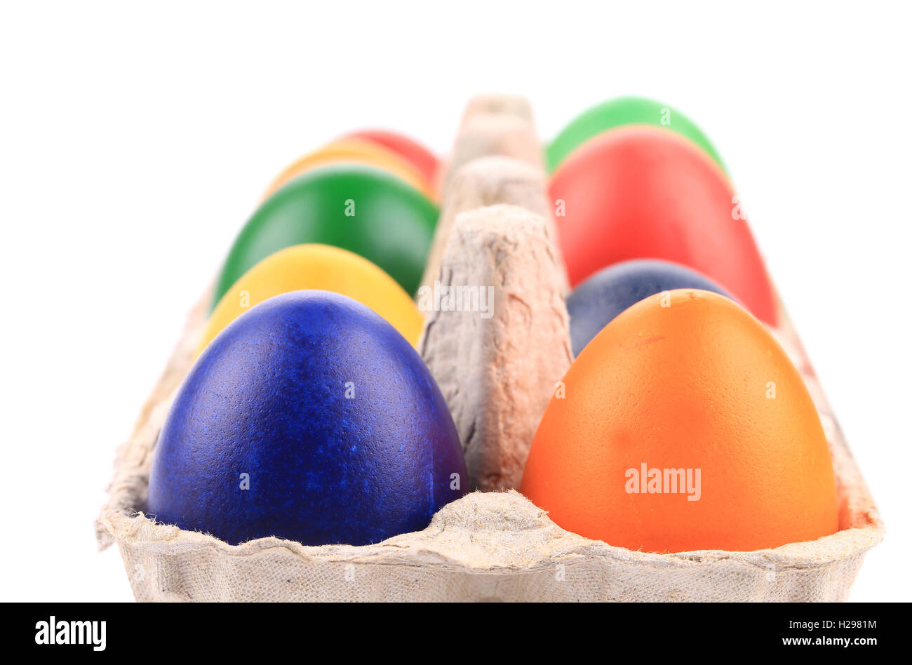 Cardboard egg box with Easter colored eggs Stock Photo - Alamy