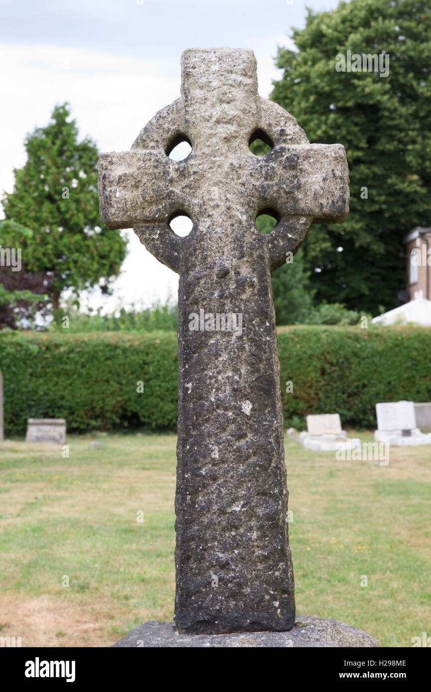 Stone cross in the grave yard of the Church of St Mary and St Peter in ...