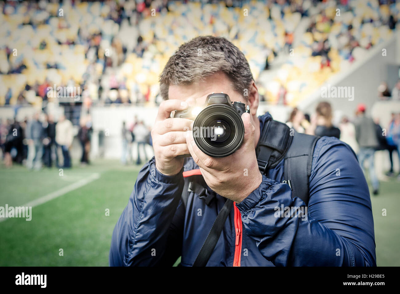 Photographer takes a photo at the stadium, with the flash Stock Photo ...