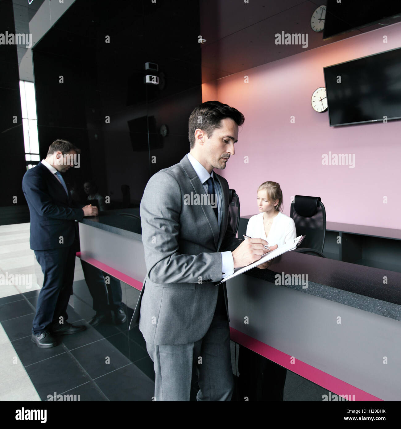Woman Filling Form Reception Desk High Resolution Stock Photography and ...