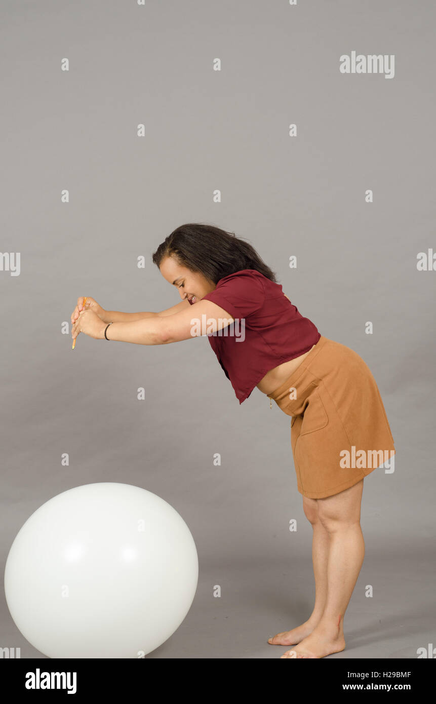Adult woman bursting huge balloon hi-res stock photography and images ...