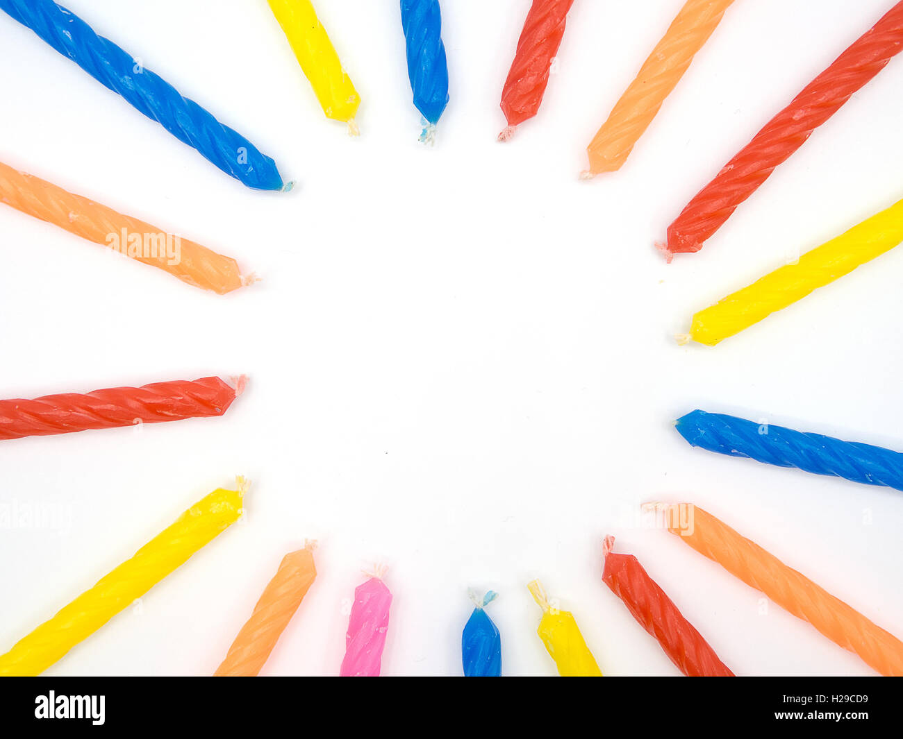 multiple color birthday candles place round form on the white ...