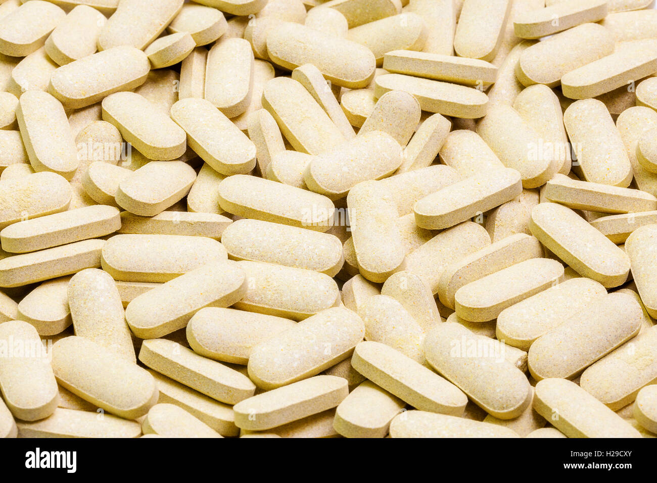 Multivitamin pills in light brown color Stock Photo - Alamy