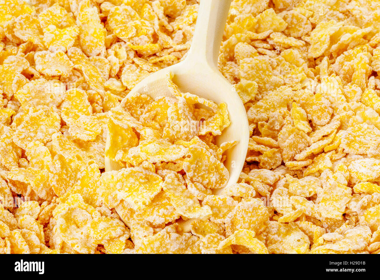 Yellow cornflakes on wooden spoon Stock Photo - Alamy