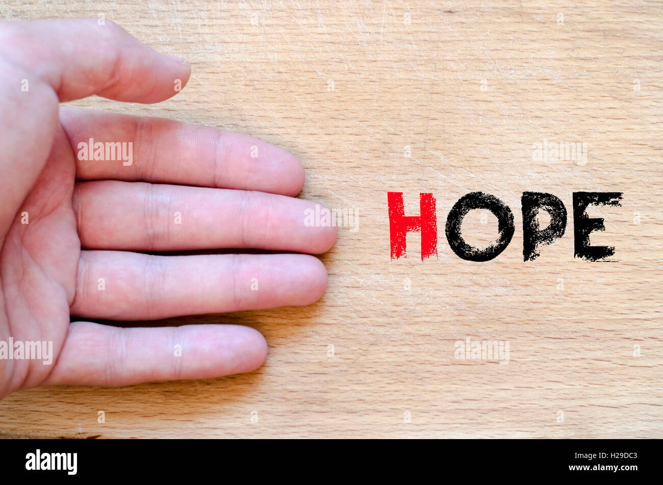 Human hand over wooden background and hope text concept Stock Photo - Alamy