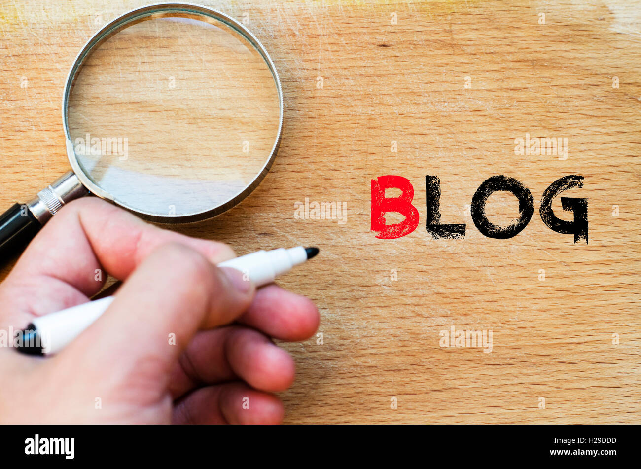 Human hand over wooden background and blog text concept Stock Photo - Alamy