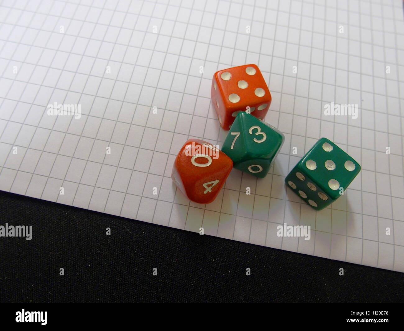 Four dices on a paper Stock Photo - Alamy