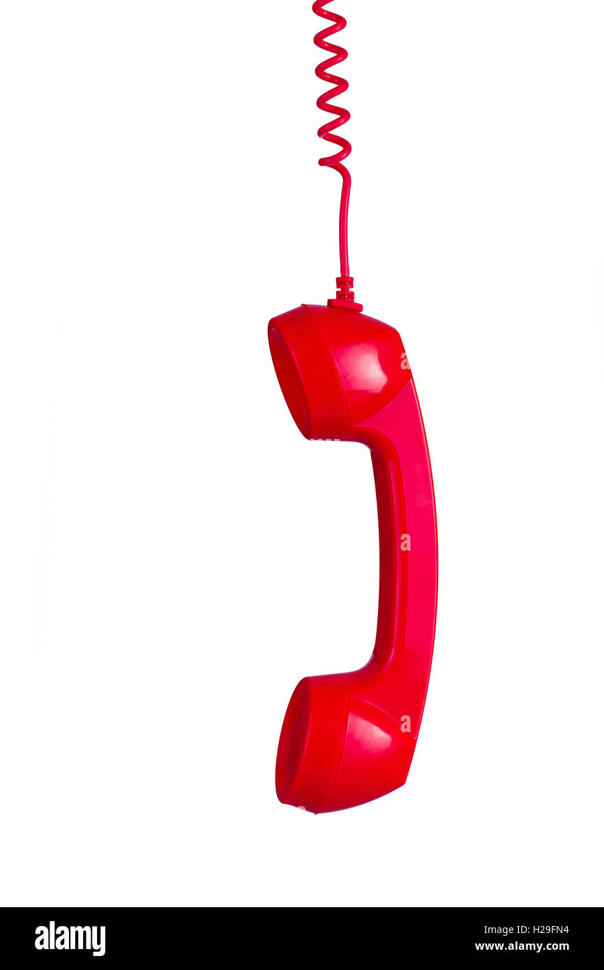 Red phone headset hanging by its wire isolated on white background ...