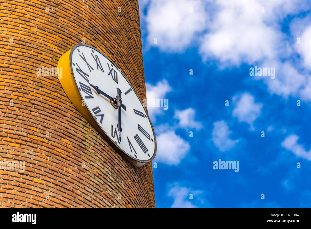 clock tower on bright blue cloudy sky Stock Photo - Alamy