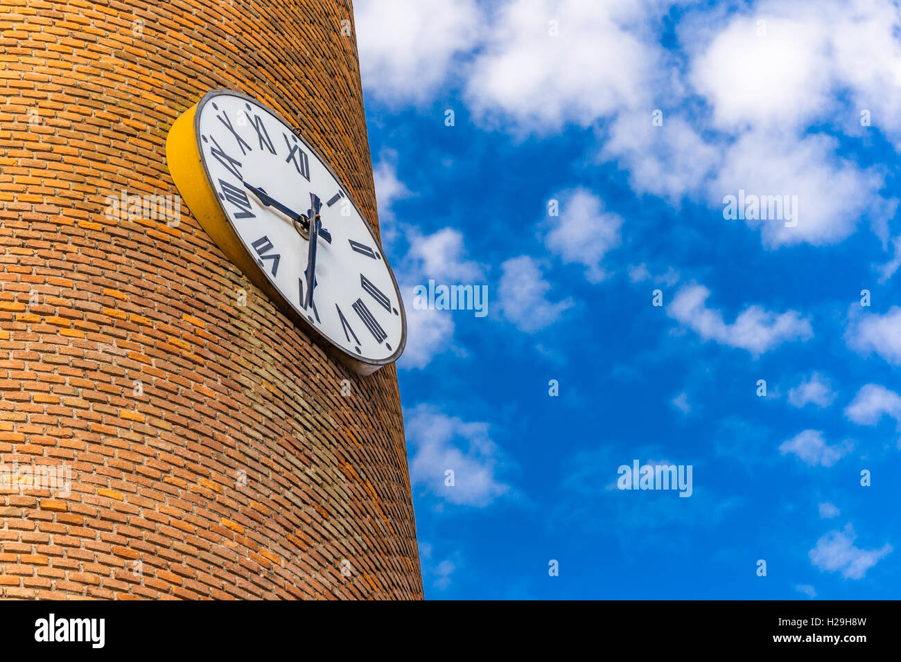 clock tower on bright blue cloudy sky Stock Photo - Alamy