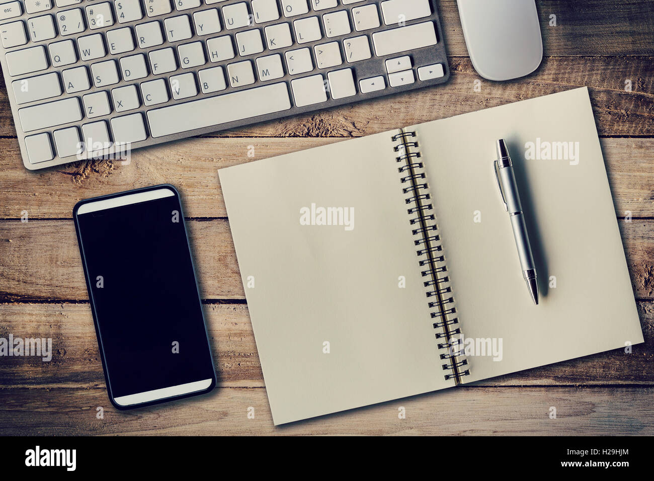 Office table with computer, phone, notebook and pen. View from above ...